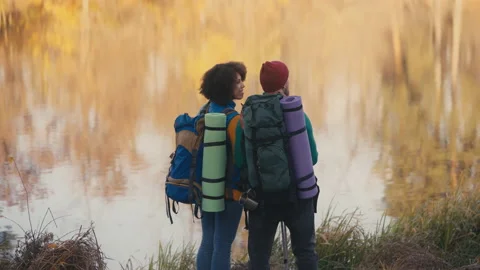Young couple with backpacks hugging near... | Stock Video | Pond5