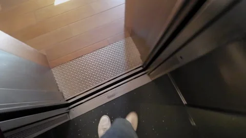 Young couple exit elevator. Doors open, ... | Stock Video | Pond5