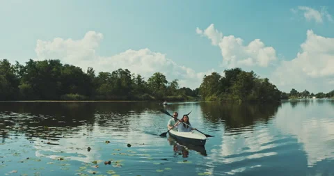 Young couple paddling in canoe front vie... | Stock Video | Pond5