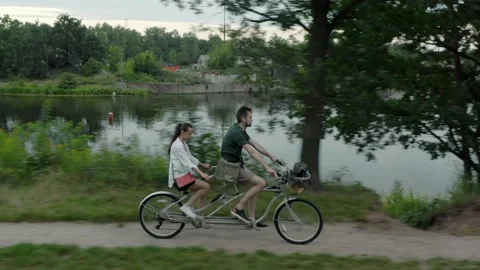 A young couple rides a tandem two-seater... | Stock Video | Pond5