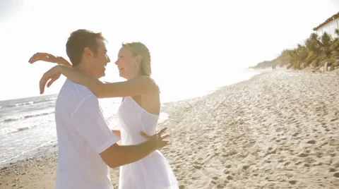 young couple twirling on beach | Stock Video | Pond5