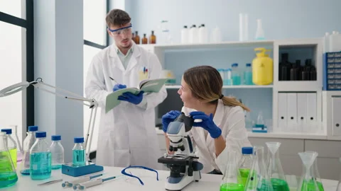 Young couple wearing scientist uniform u... | Stock Video | Pond5