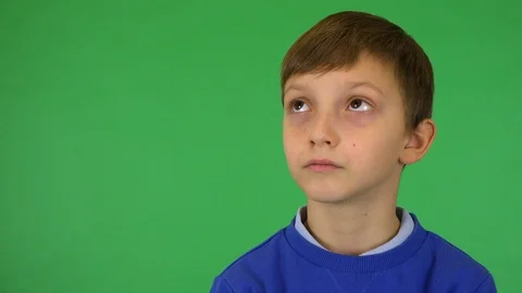 A young cute boy looks around - closeup ... | Stock Video | Pond5