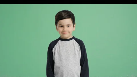 Young cute boy staring and smiling at th... | Stock Video | Pond5