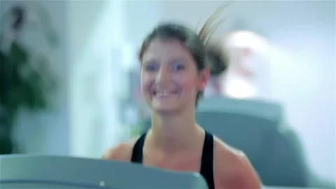 Young cute girl running in the gym smili... | Stock Video | Pond5