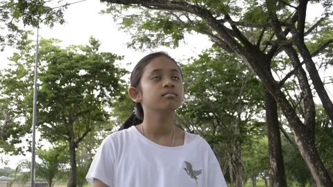 Young cute girl walking on the pathway i... | Stock Video | Pond5