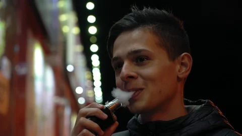 young cute man vaping near entertainment... | Stock Video | Pond5