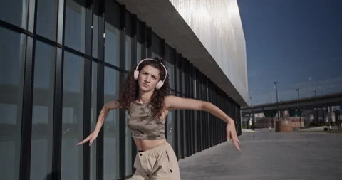 Young dancer performing near glass wall | Stock Video | Pond5