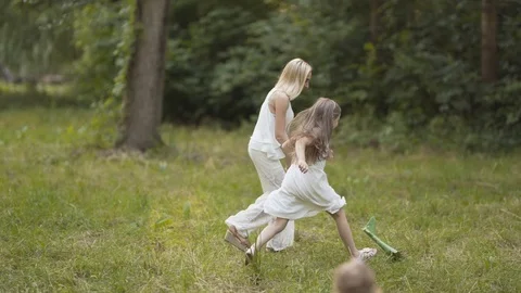 Young daughter throwing a toy airplane t... | Stock Video | Pond5
