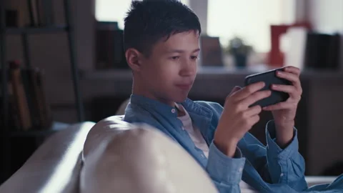 Young Digital Explorer: Boy Sitting on S... | Stock Video | Pond5