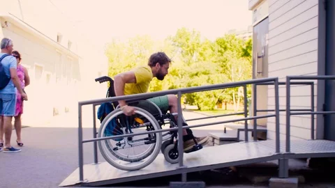 Young disable man in wheelchair in the p... | Stock Video | Pond5