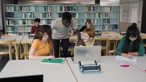 Young diverse people studying in library... | Stock Video | Pond5