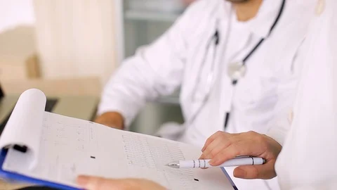 Young Doctors Comparing Data From Patien... | Stock Video | Pond5