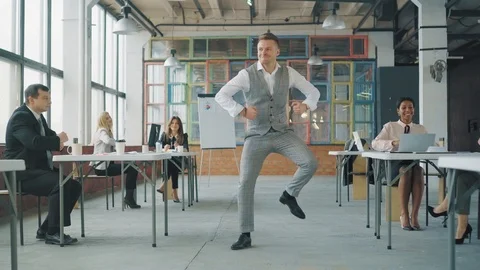 A young employee is fun dancing in the o... | Stock Video | Pond5