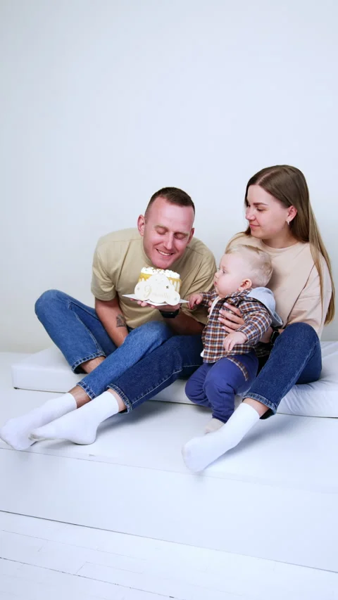 Young family of three sitting on the flo... | Stock Video | Pond5