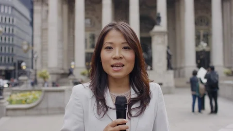 Young female Asian news reporter outside... | Stock Video | Pond5