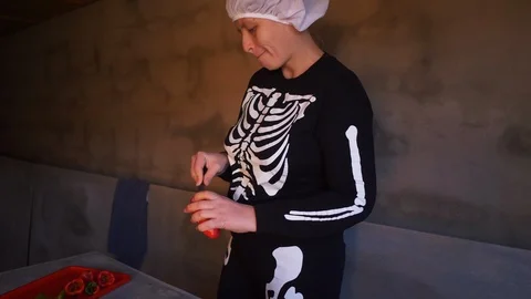 Young female cook in skeleton costume an... | Stock Video | Pond5