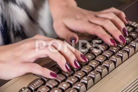 Young female hands typing on old computer keyboard in office on desk ...