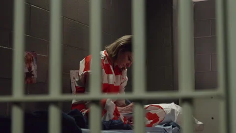 Young female inmate is writing note in h... | Stock Video | Pond5