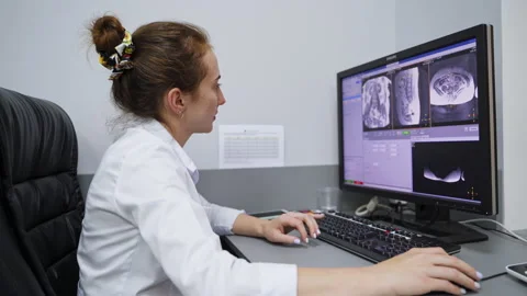 Young female medic at the computer analy... | Stock Video | Pond5