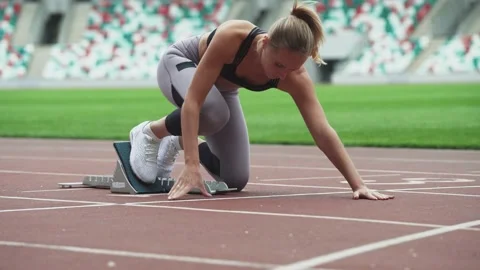 Young female sprinter is preparing for t... | Stock Video | Pond5