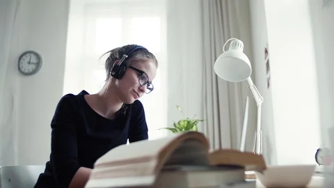 A young female student sitting at the ta... | Stock Video | Pond5