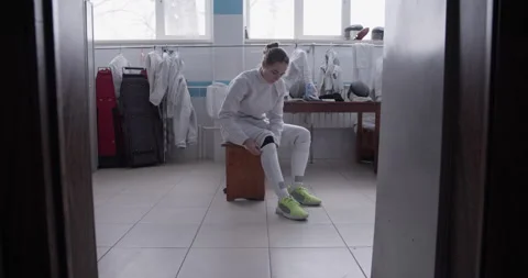 Young fencer adjusting socks before trai... | Stock Video | Pond5