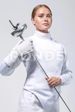 Young fencer athlete wearing fencing costume holding the sword and mask ~ Premium Photo #99201279