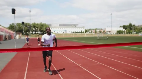 Young fit black man crossing finish line... | Stock Video | Pond5