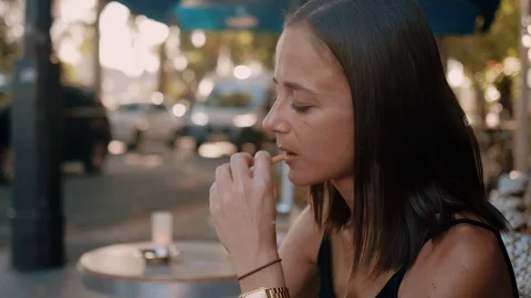 Young French woman smokes a cigarette wh... | Stock Video | Pond5