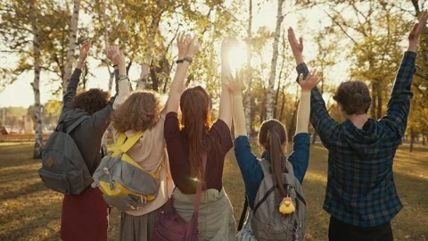 Young friends raising their hands up in ... | Stock Video | Pond5
