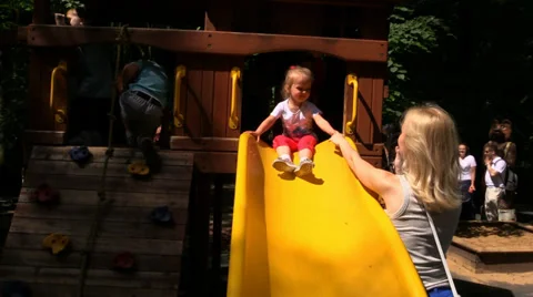 Young Girl Afraid to Ride Slide at Child... | Stock Video | Pond5
