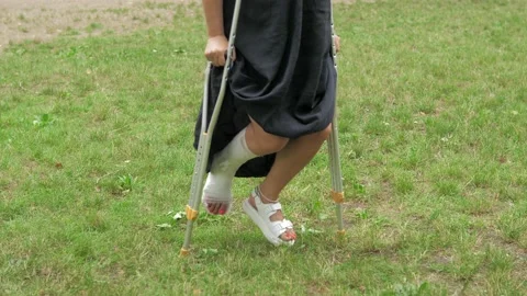 A young girl with a cast walks around th... | Stock Video | Pond5