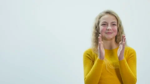 Young girl clapping hands on white backg... | Stock Video | Pond5