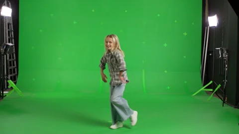 Young girl dancing on a green screen bac... | Stock Video | Pond5