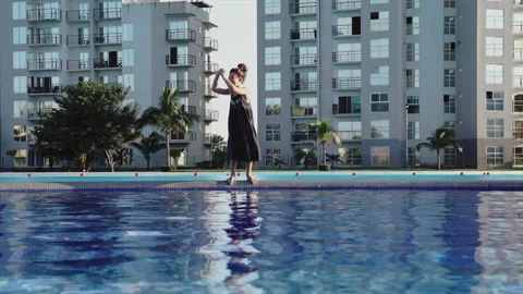 Young girl dancing by the pool before ju... | Stock Video | Pond5