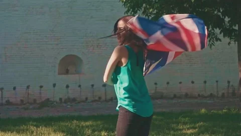 Young girl dancing with union jack flag | Stock Video | Pond5