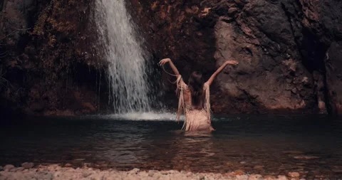 A young girl enters the water, stops in ... | Stock Video | Pond5