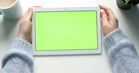 Young girl hold white taplet with green ... | Stock Video | Pond5