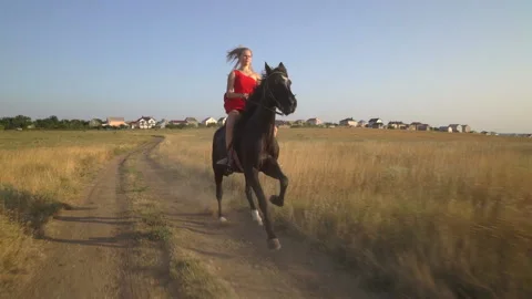 Young girl horseback rider in red dress ... | Stock Video | Pond5