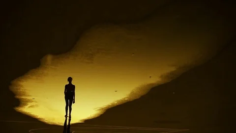 A young girl is jumping in a puddle. Goo... | Stock Video | Pond5