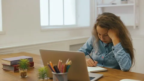 Young girl with laptop computer is doing... | Stock Video | Pond5