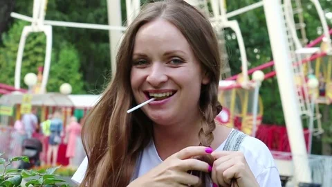 A young girl with long hair lishes lolli... | Stock Video | Pond5