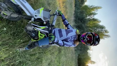 Young girl in a motorcycle helmet, a bik... | Stock Video | Pond5