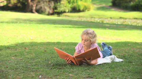 Young girl reading a book | Stock Video | Pond5