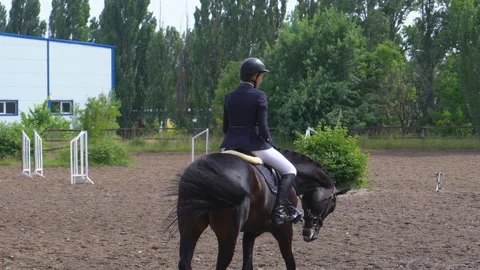 A young girl rider rides a horse riding ... | Stock Video | Pond5
