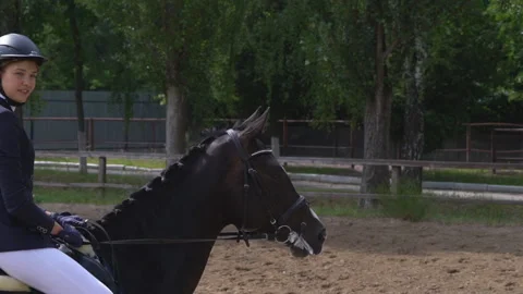 A young girl rider rides a horse riding ... | Stock Video | Pond5