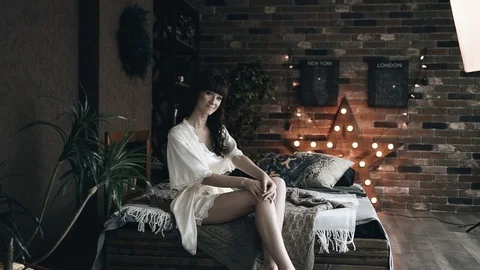 A young girl is sitting on the edge of t... | Stock Video | Pond5