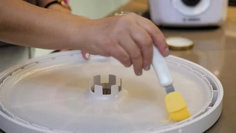 A young girl smears coconut oil on the b... | Stock Video | Pond5