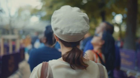 Young girl standing in the queue | Stock Video | Pond5